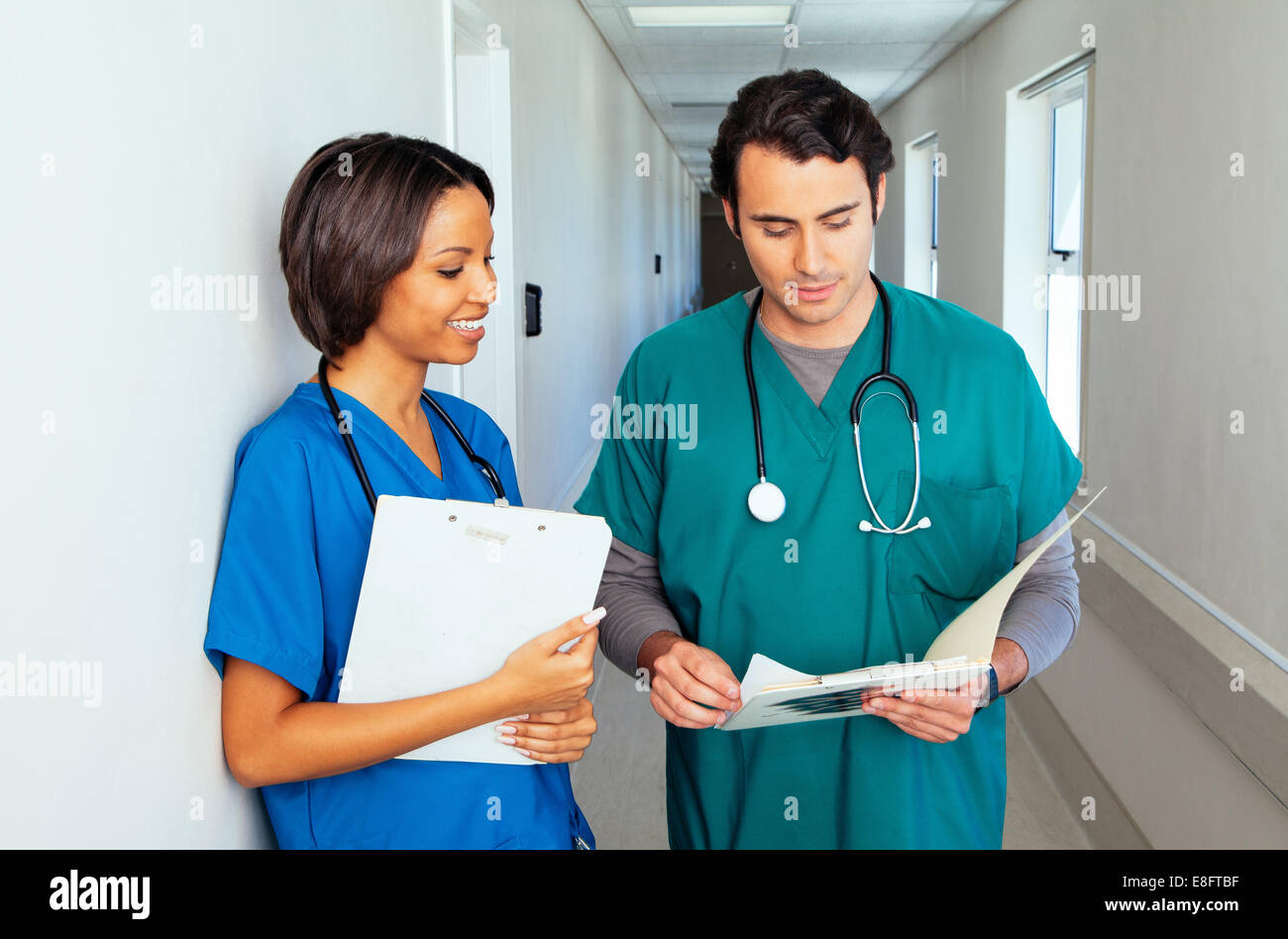Two doctors talking in hospital corridor Stock Photo - Alamy