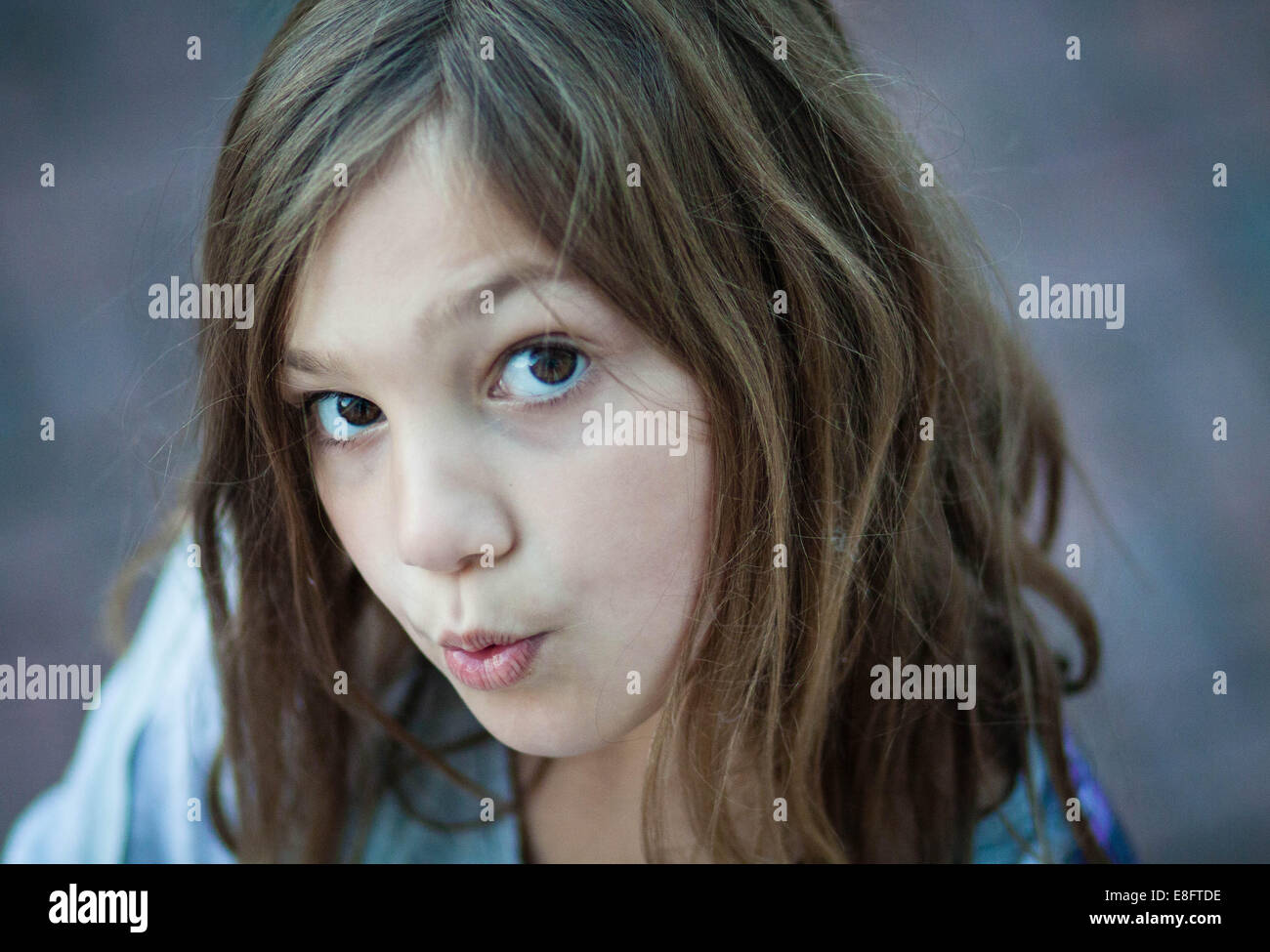 Portrait of girl puckering lips Stock Photo - Alamy