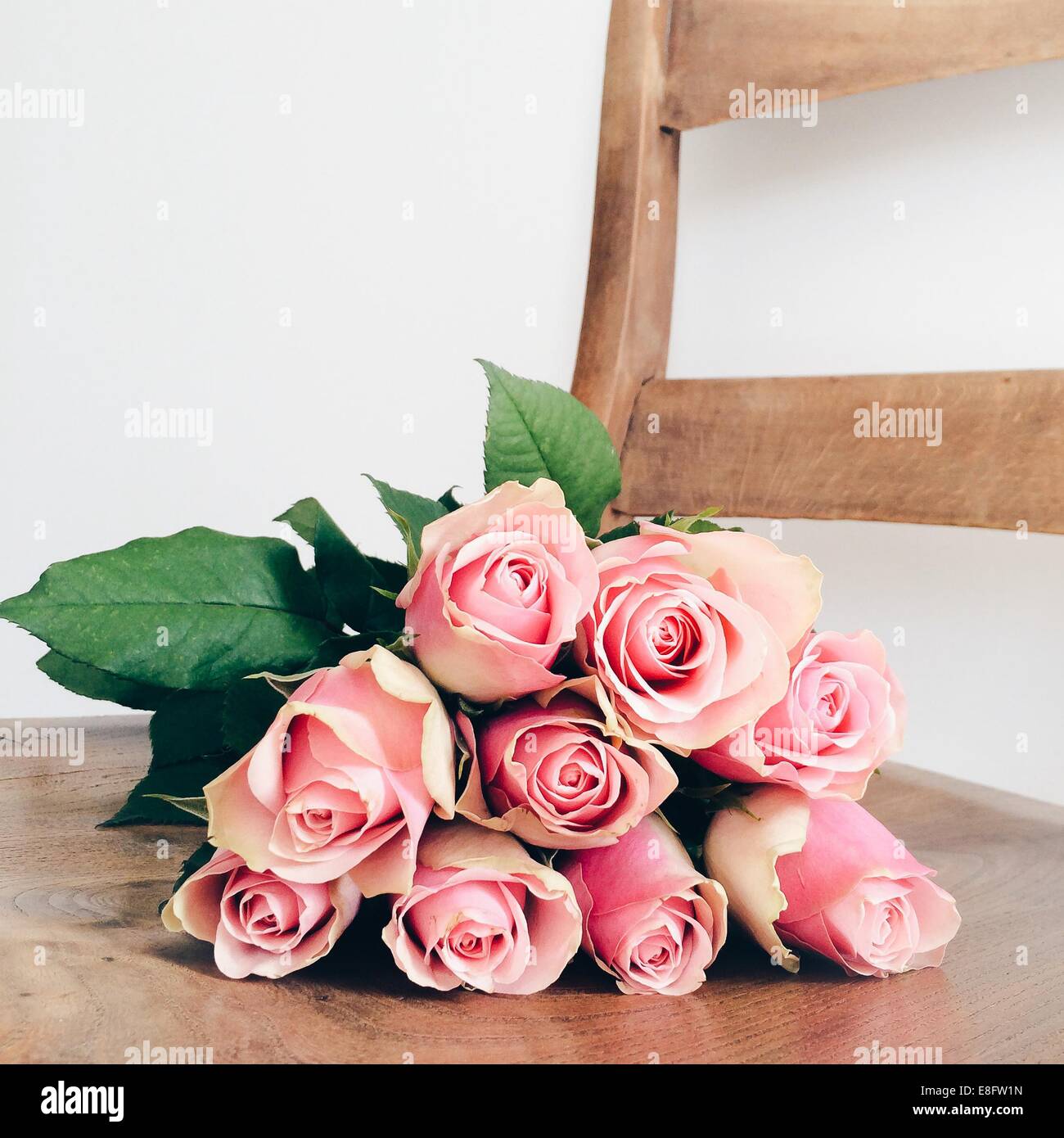 Bouquet of Pink roses lying on chair Stock Photo - Alamy