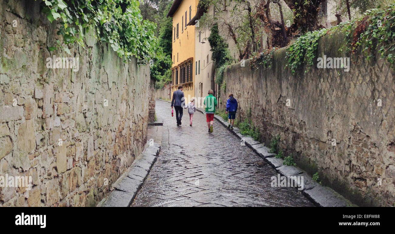 Father and three children walking down street, Florence, Tuscany, Italy ...