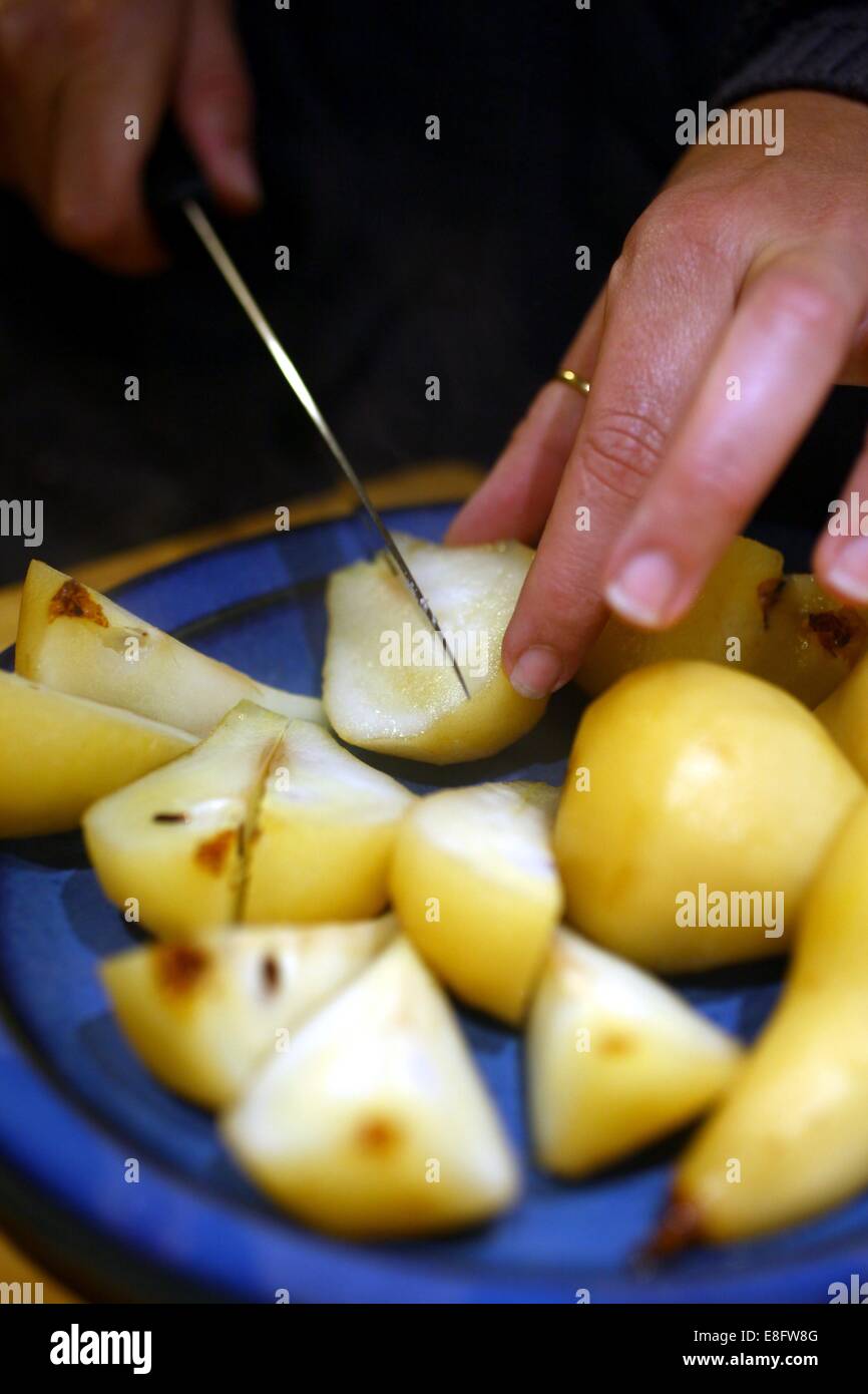 Woman's hand cutting pears Stock Photo - Alamy