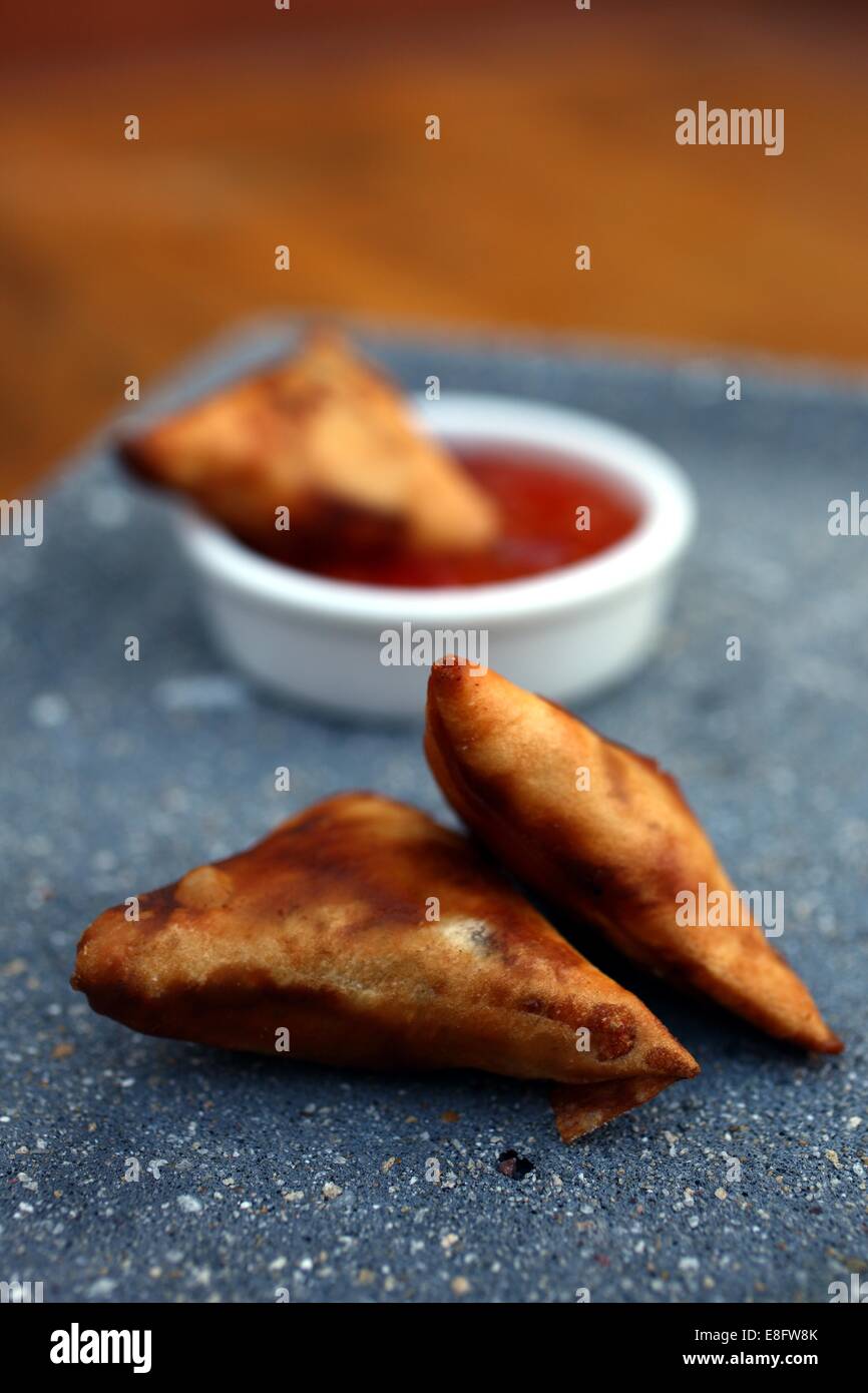 Samosas with spicy dip Stock Photo - Alamy