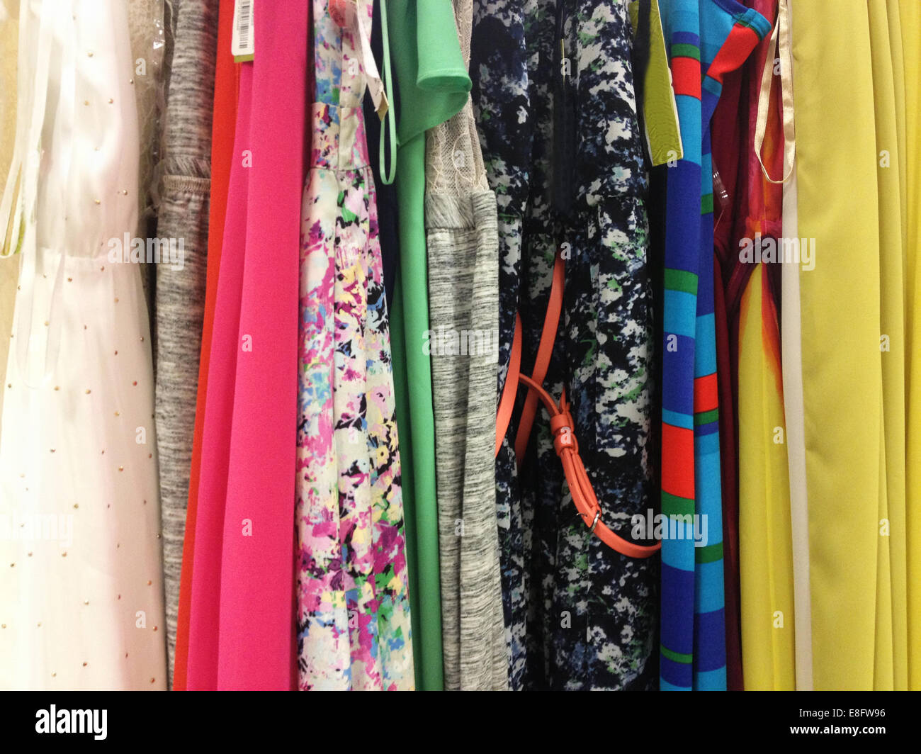 Women's clothes hanging on clothes rail Stock Photo - Alamy