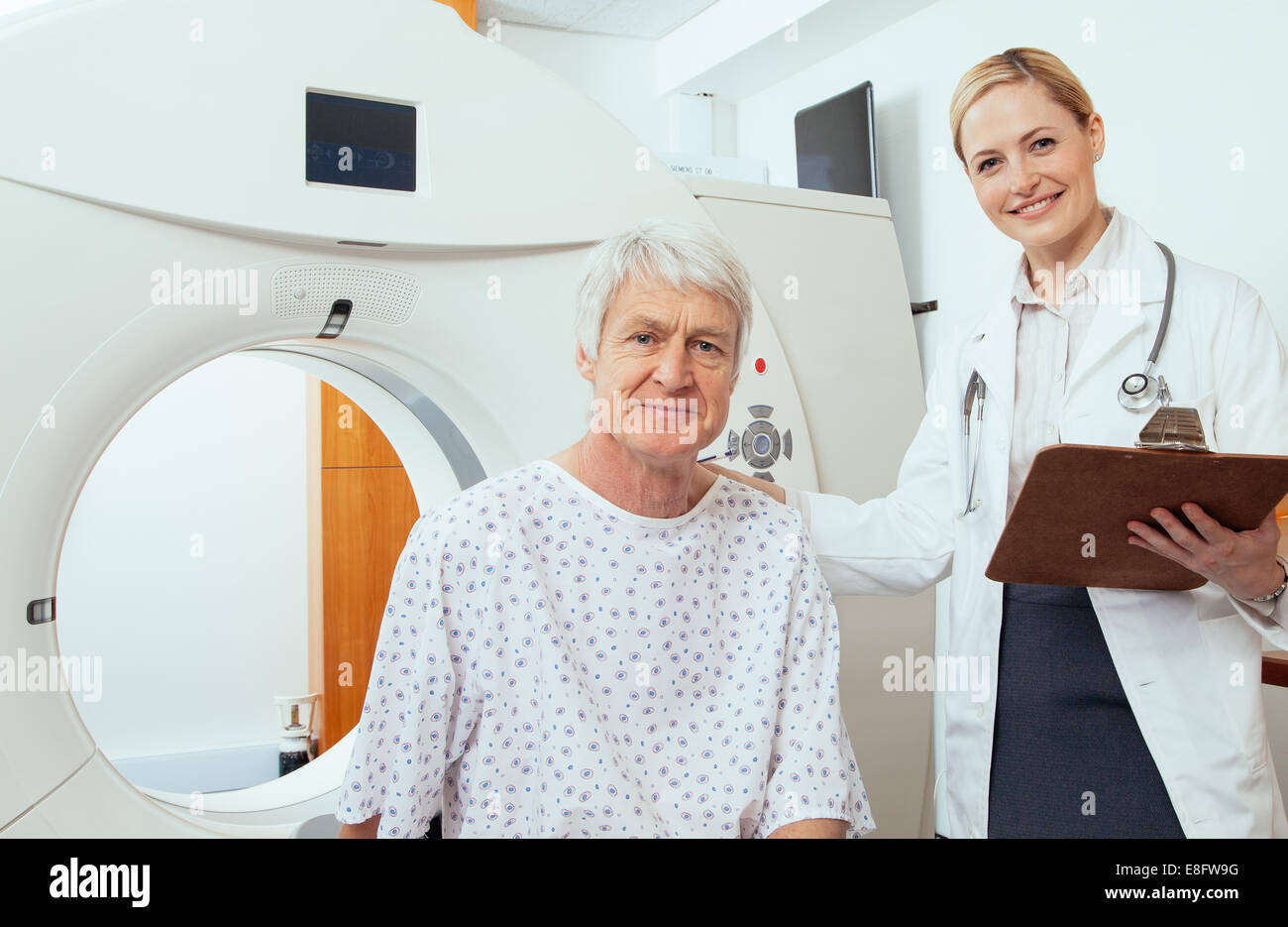 Portrait of a female doctor with a mature patient about to have an MRI ...