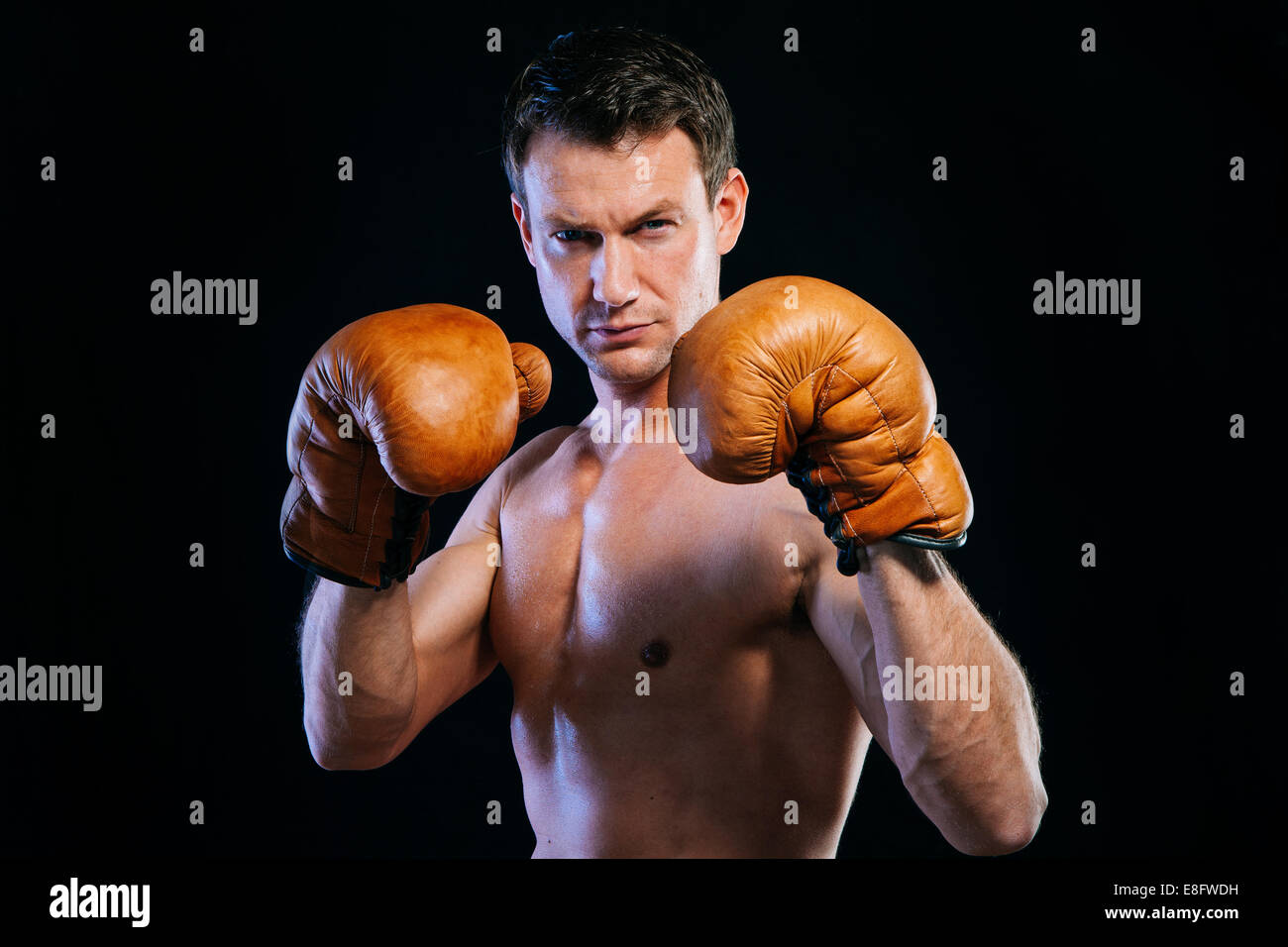 Portrait of a male boxer with his fists raised ready to fight Stock ...