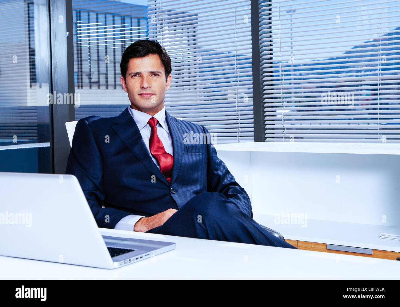 Businessman sitting at his desk in the office Stock Photo - Alamy
