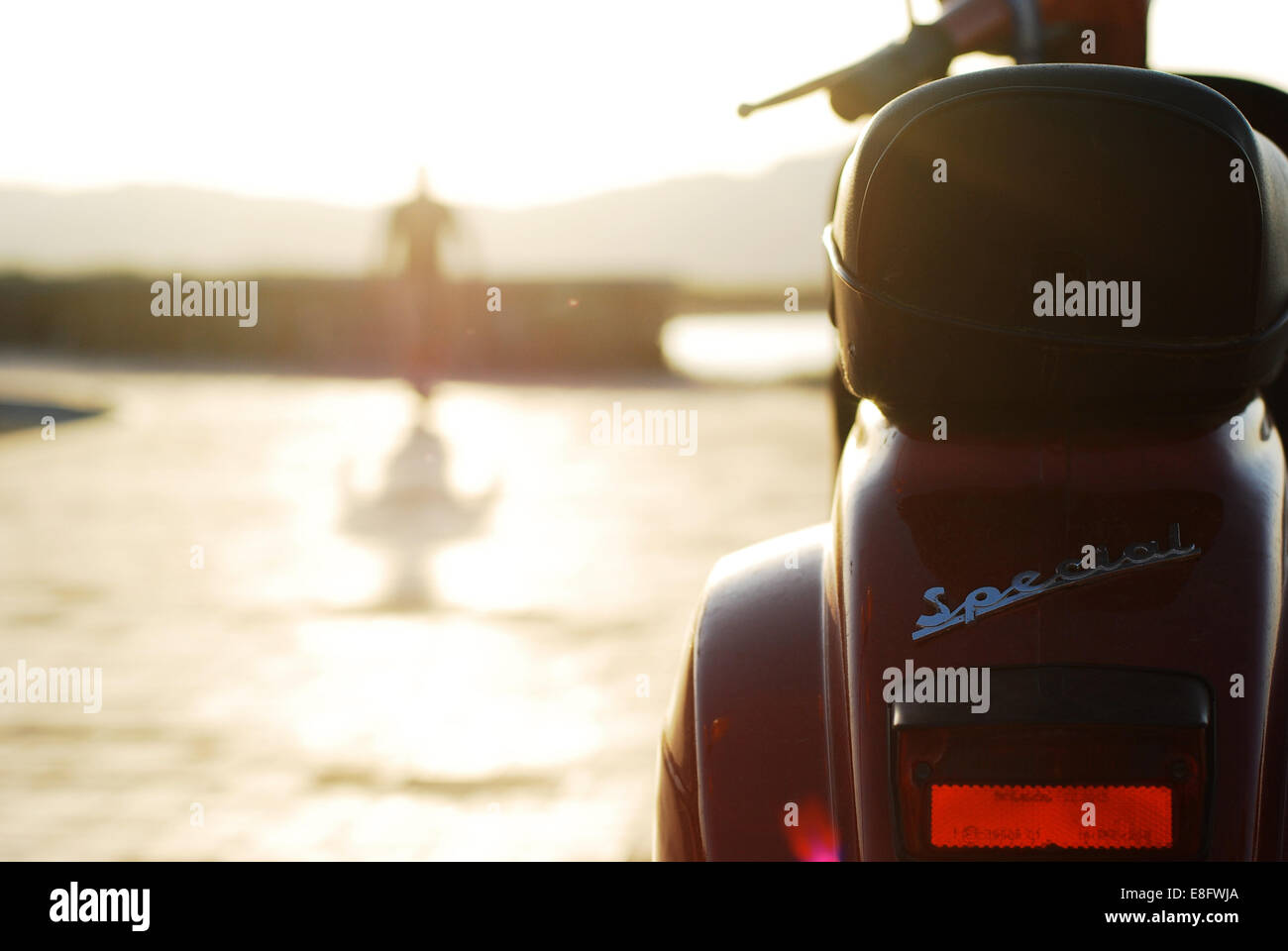 Man walking towards motor scooter Stock Photo - Alamy