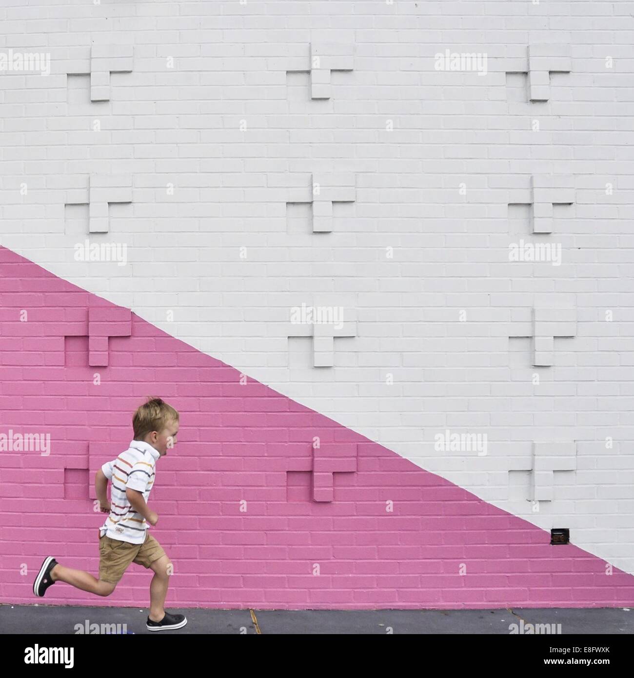 Boy running past pink white hi-res stock photography and images - Alamy