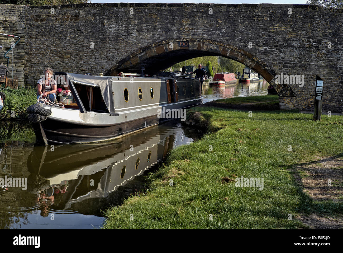 Oxford canal. Narrow boat navigating through the canal bridge on the ...