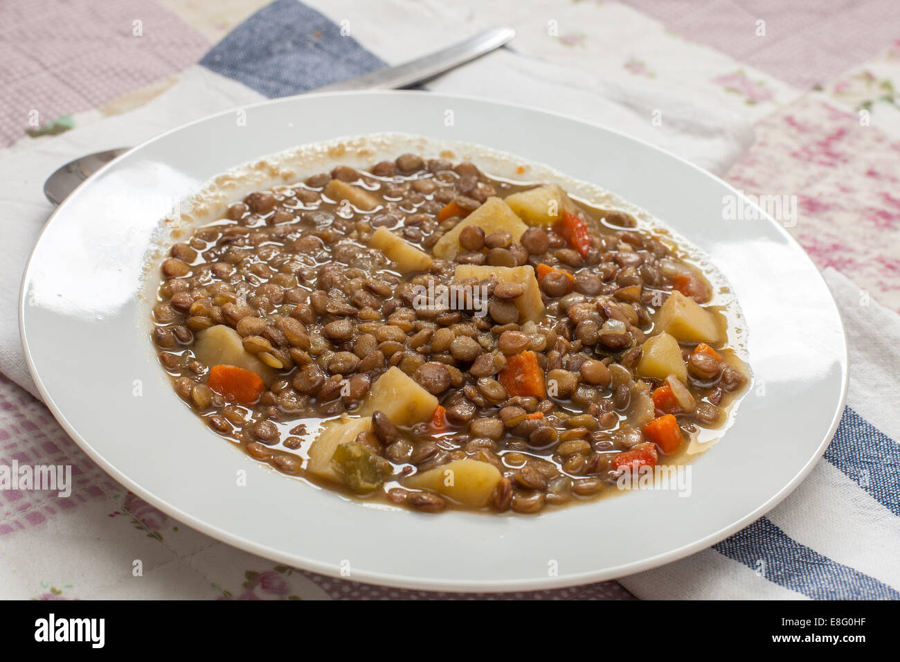 lentil with vegetables served on white plate Stock Photo - Alamy