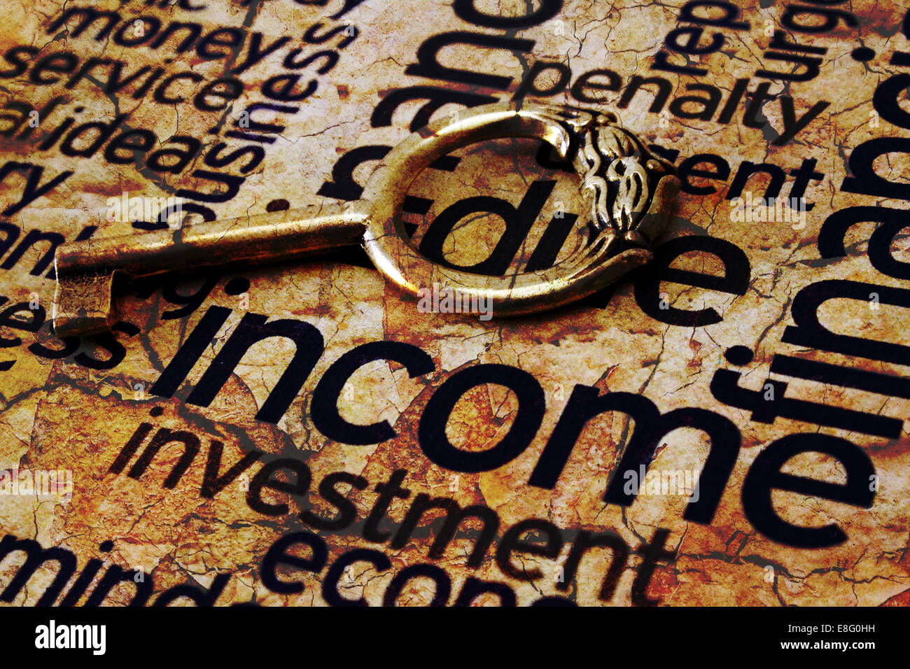 Golden key on income text Stock Photo - Alamy