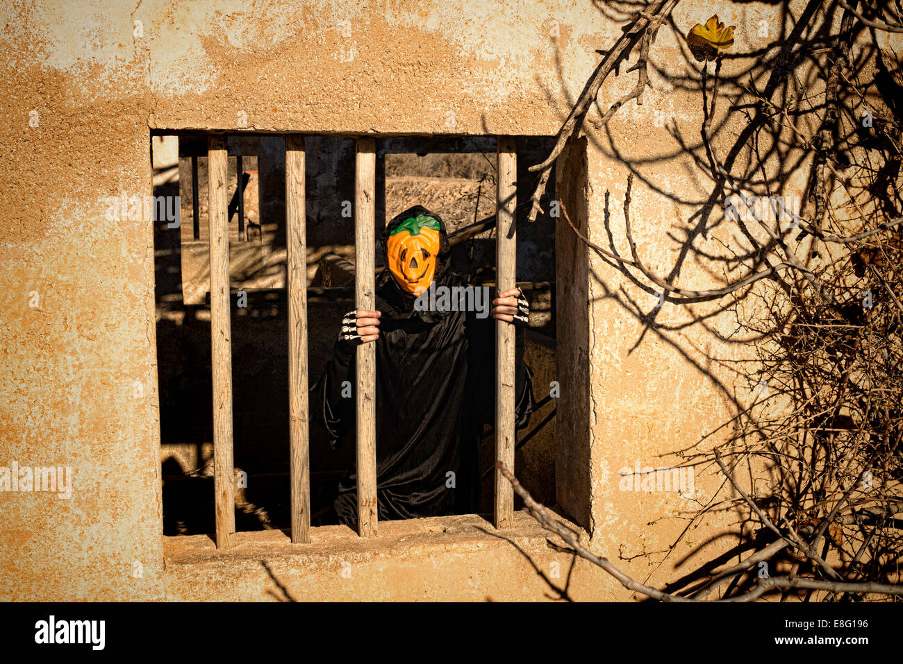 Halloween monster locked in behind window bars Stock Photo - Alamy