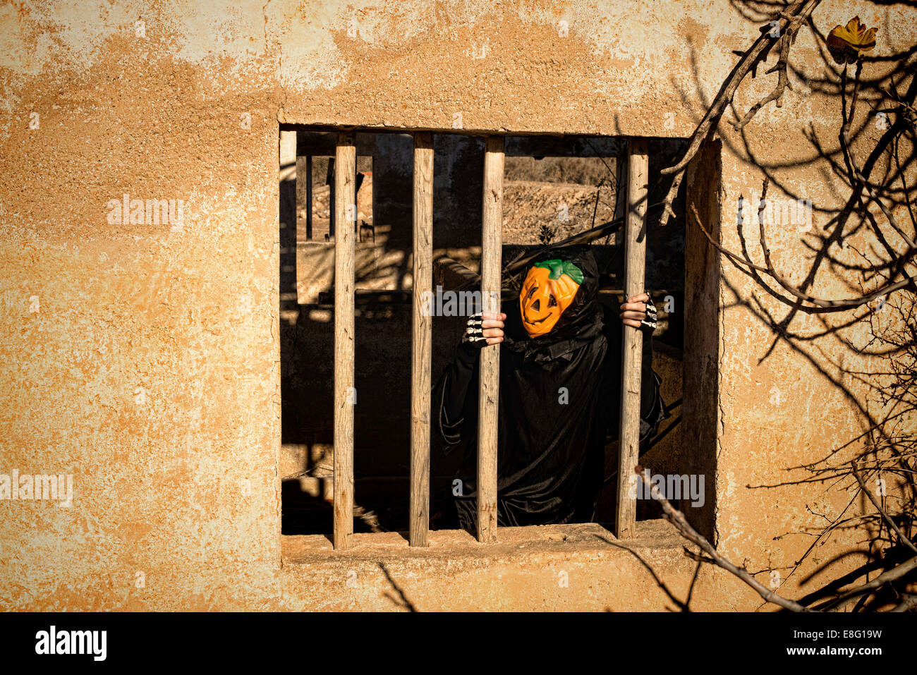Halloween monster locked in behind window bars Stock Photo - Alamy