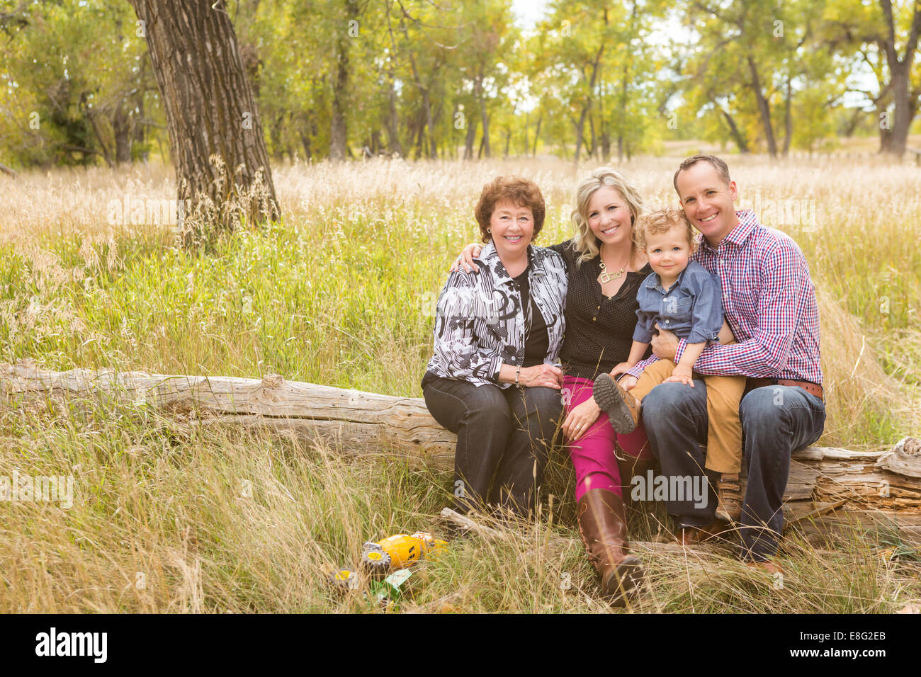 Lovely family enjoying weekend in open space park in early Autumn Stock ...