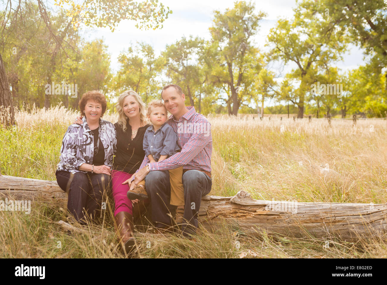 Lovely family enjoying weekend in open space park in early Autumn Stock ...