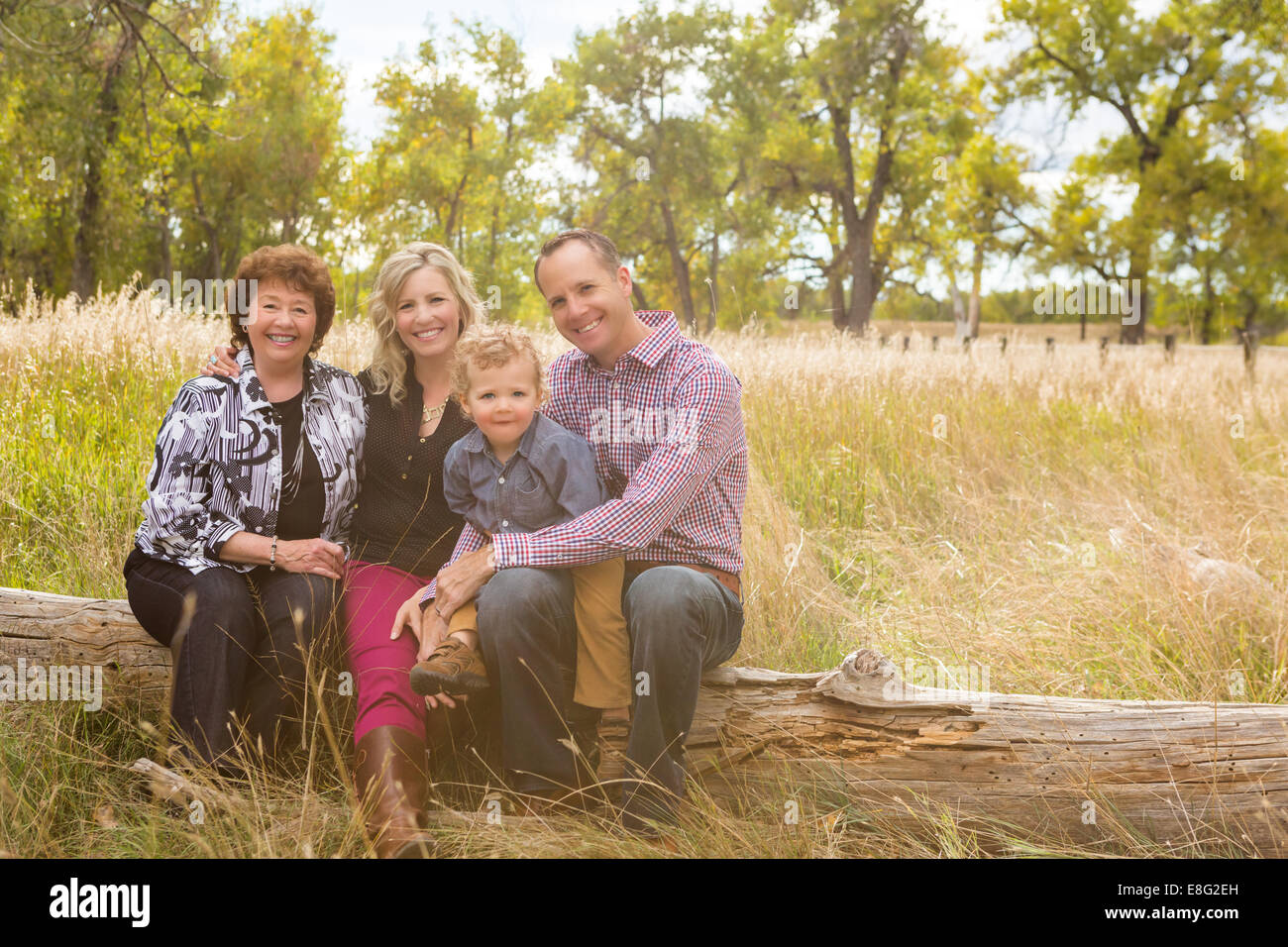 Lovely family enjoying weekend in open space park in early Autumn Stock ...