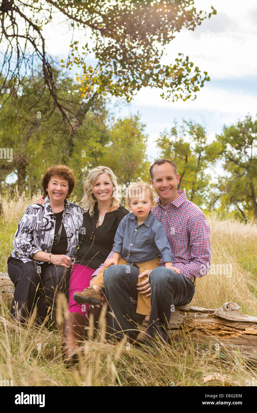 Lovely family enjoying weekend in open space park in early Autumn Stock ...