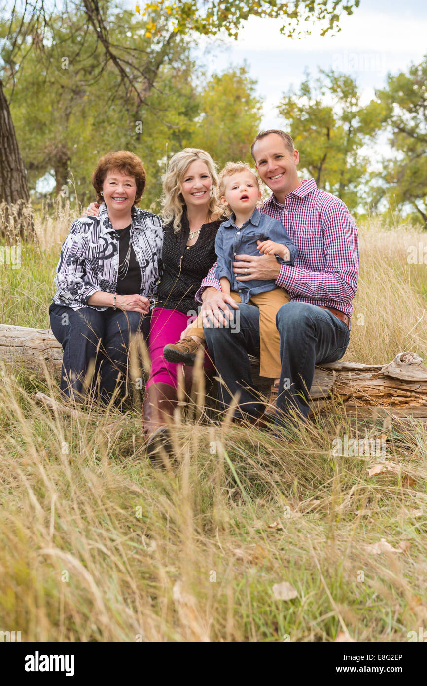 Lovely family enjoying weekend in open space park in early Autumn Stock ...