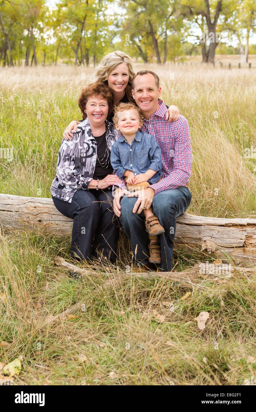 Lovely family enjoying weekend in open space park in early Autumn Stock ...