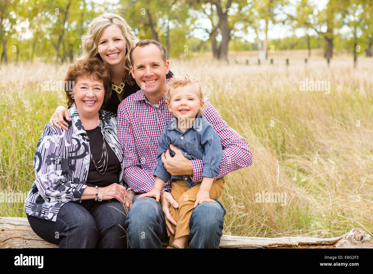Lovely family enjoying weekend in open space park in early Autumn Stock ...
