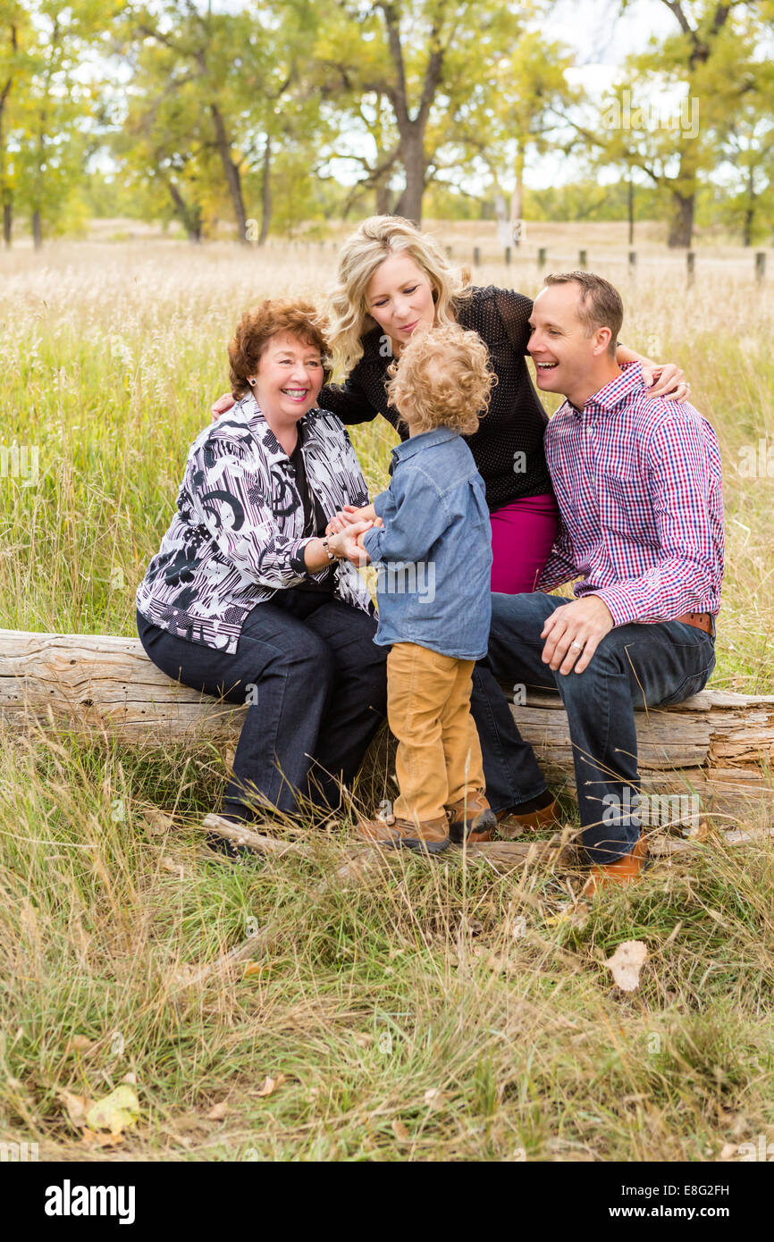 Lovely family enjoying weekend in open space park in early Autumn Stock ...
