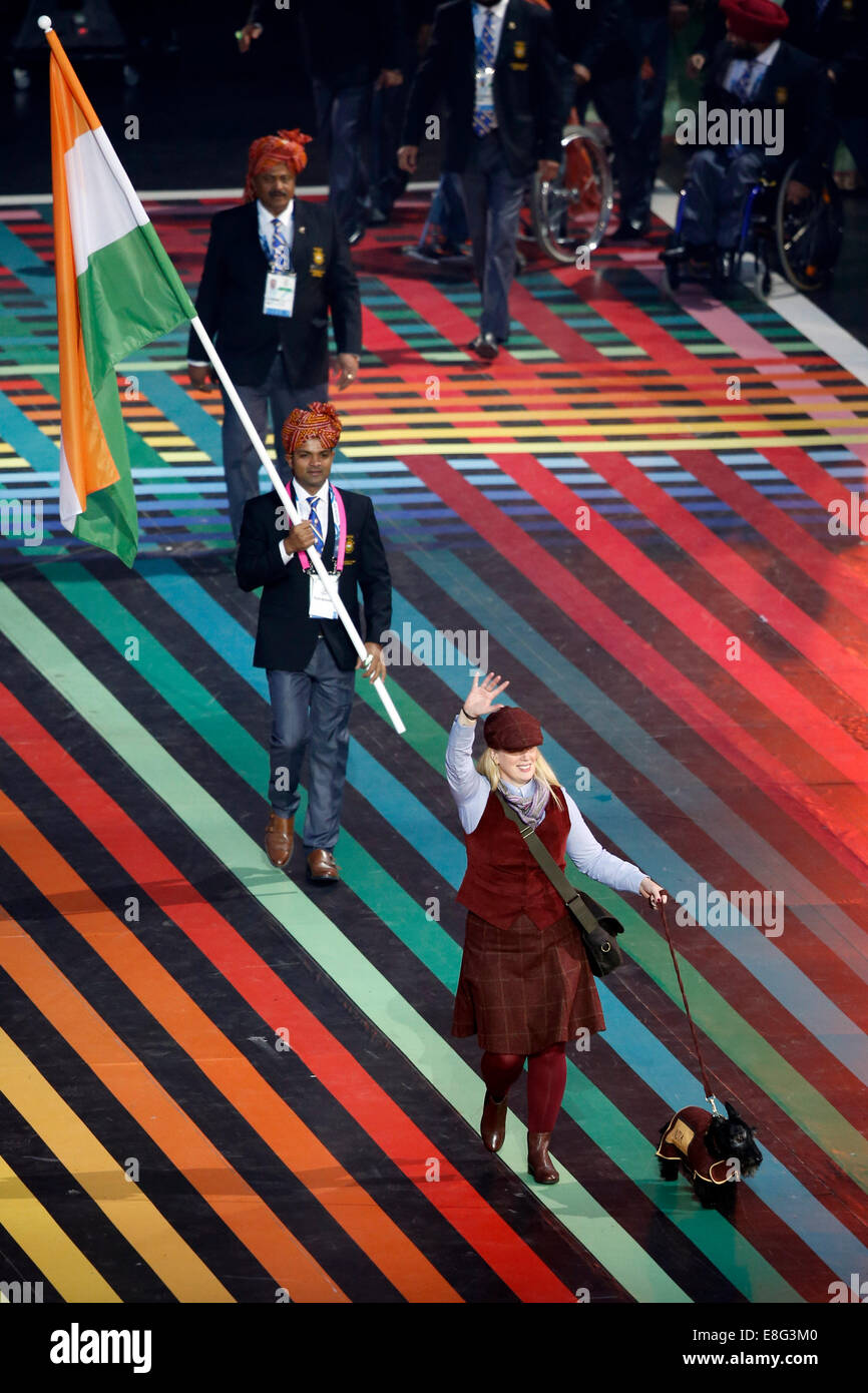 A scotty dog leads in the Indian team, with flag bearer Vijay Kumar ...