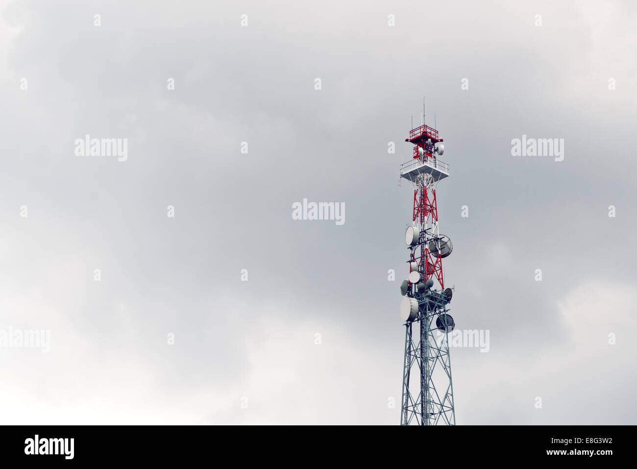 Red and white communication tower with GSM antenna transmitters Stock Photo - Alamy