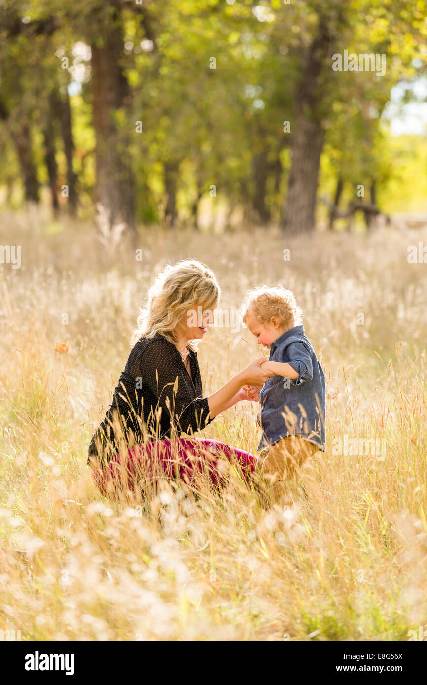 Lovely family enjoying weekend in open space park in early Autumn Stock ...