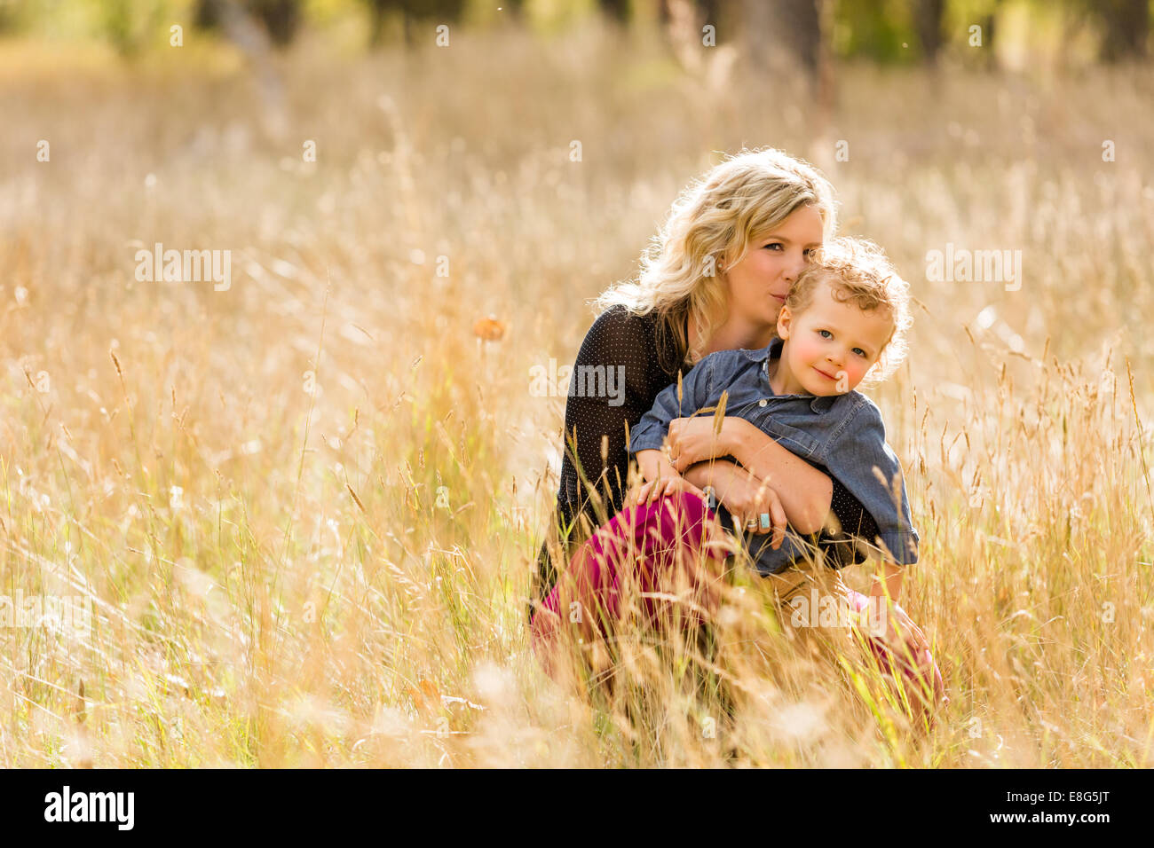 Lovely family enjoying weekend in open space park in early Autumn Stock ...