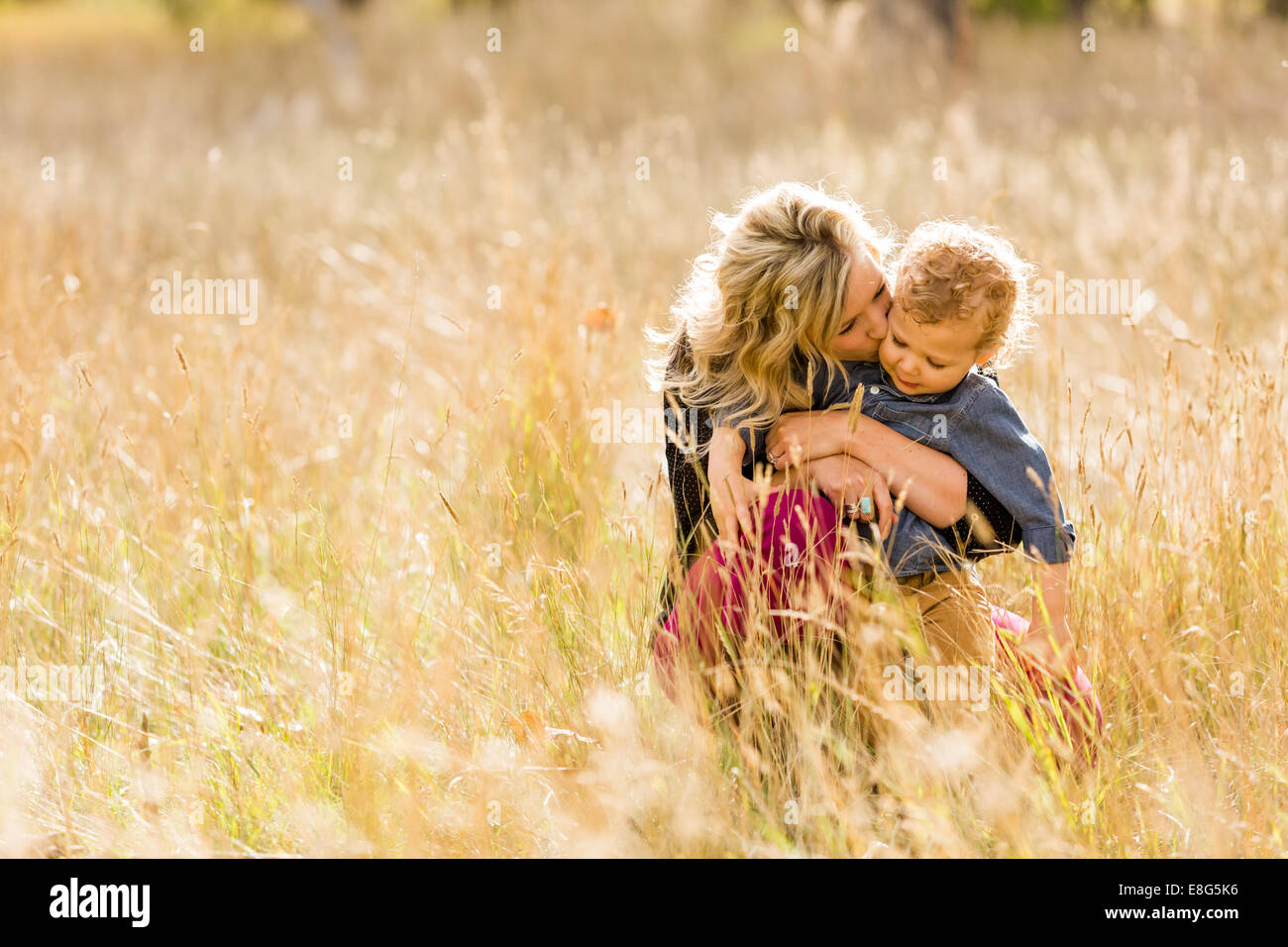 Lovely family enjoying weekend in open space park in early Autumn Stock ...