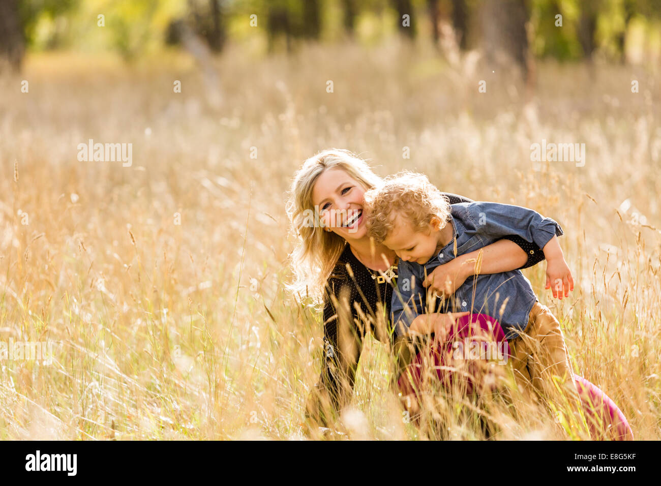 Lovely family enjoying weekend in open space park in early Autumn Stock ...