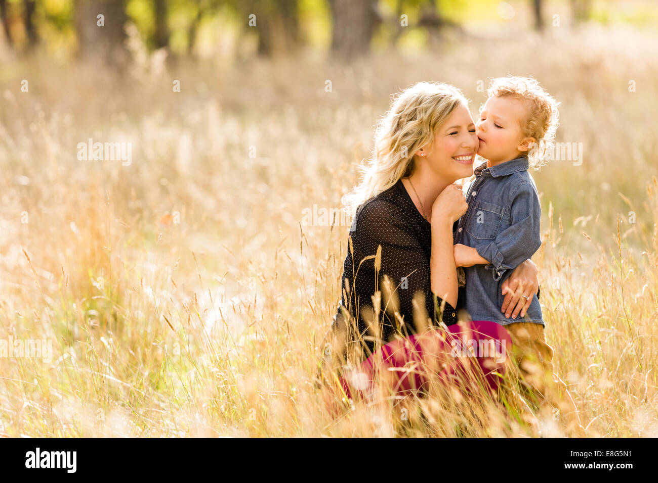 Lovely family enjoying weekend in open space park in early Autumn Stock ...