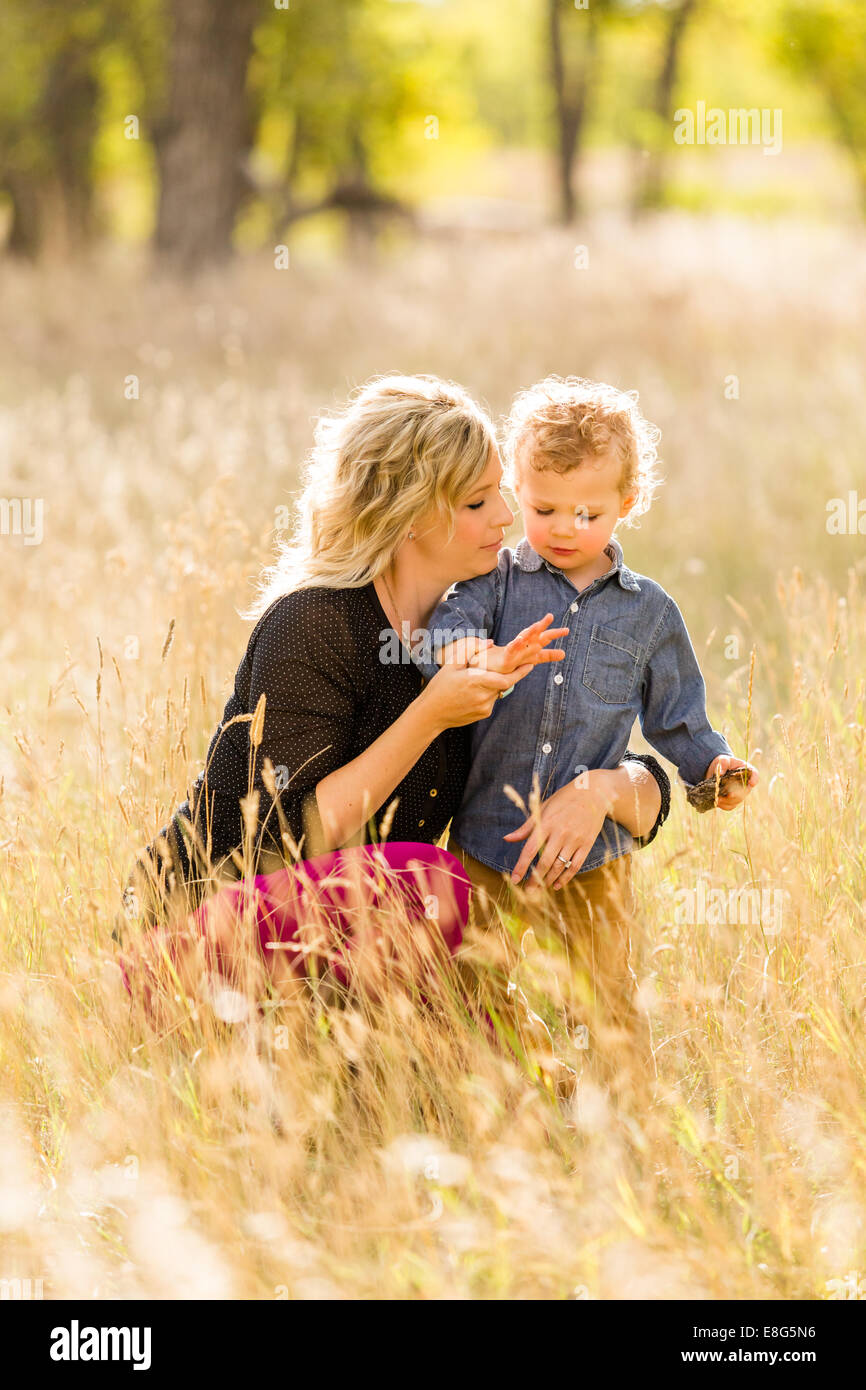 Lovely family enjoying weekend in open space park in early Autumn Stock ...