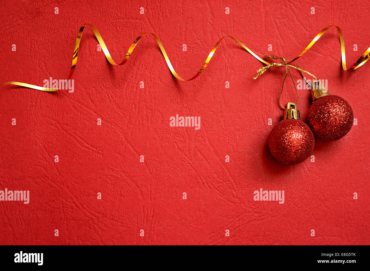 Red background with Christmas balls and streamer Stock Photo - Alamy