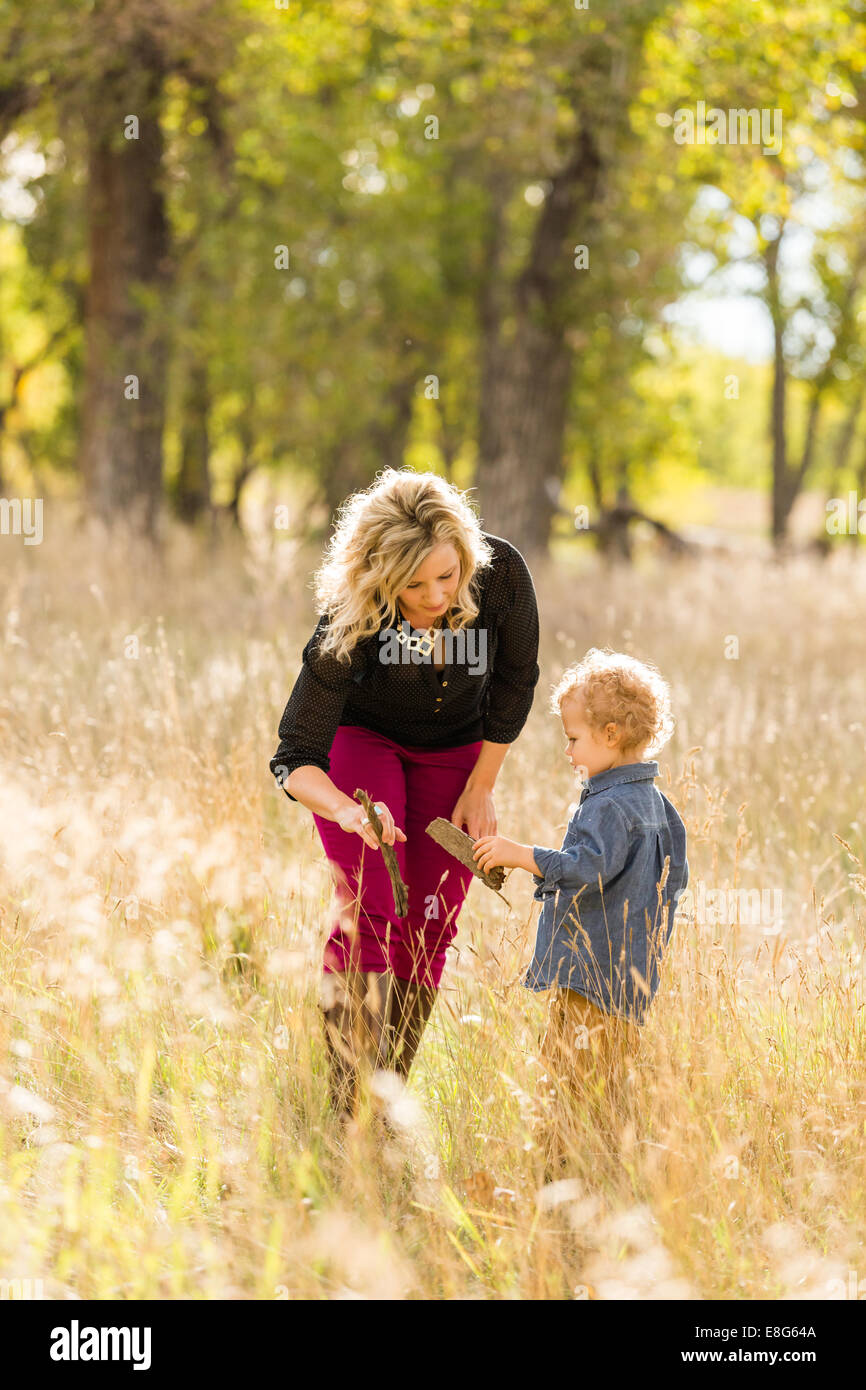 Lovely family enjoying weekend in open space park in early Autumn Stock ...
