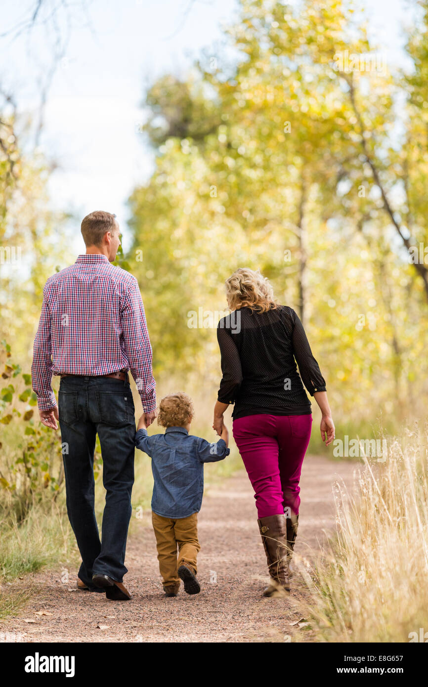 Lovely family enjoying weekend in open space park in early Autumn Stock ...