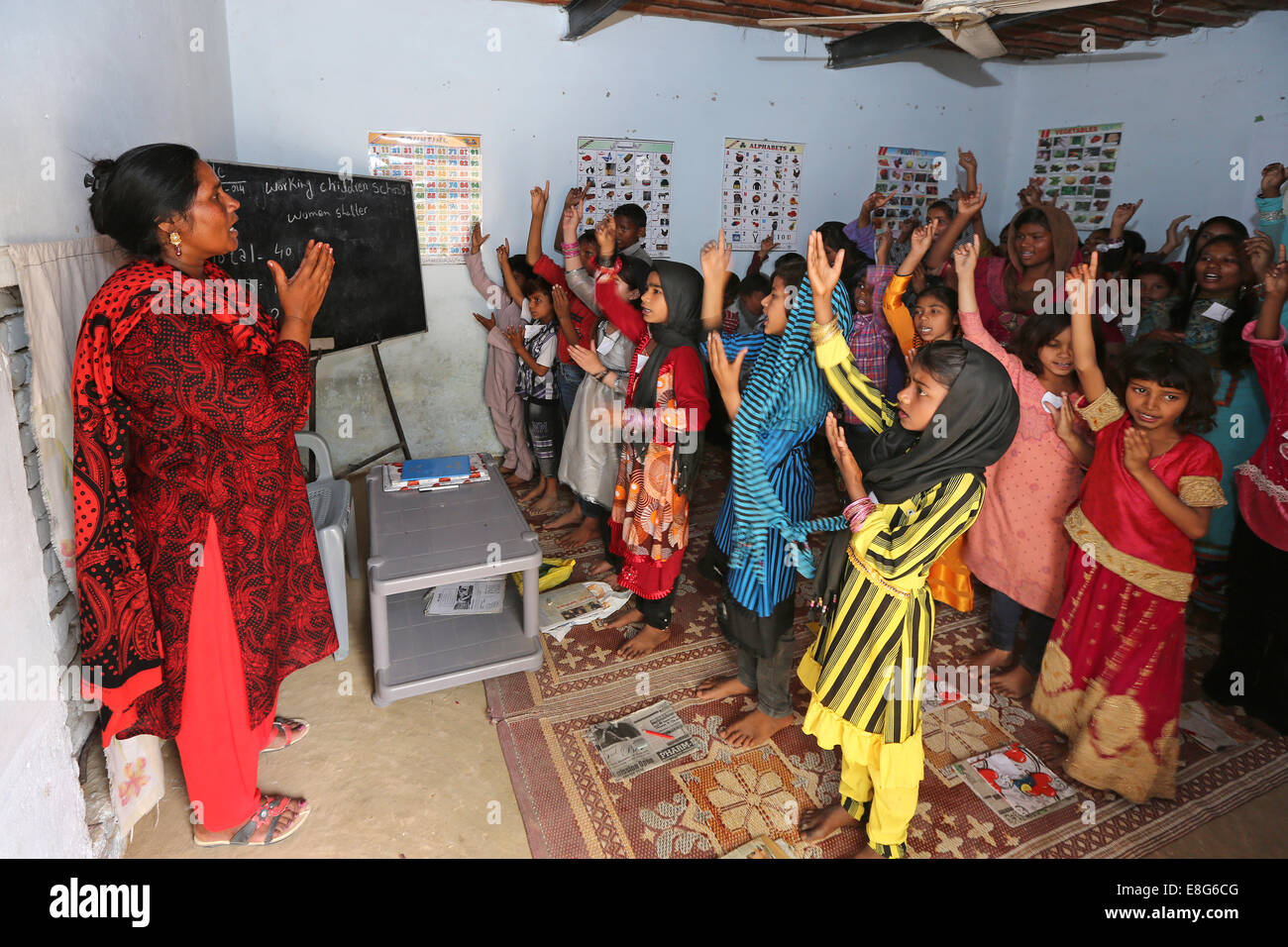 Children with their teacher in a classroom of a school in a village ...