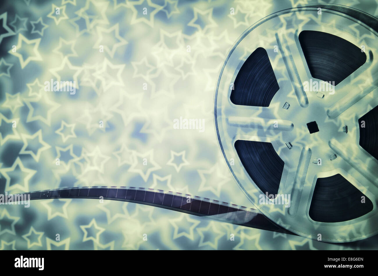Motion picture film reel with strip and stars background Stock Photo ...