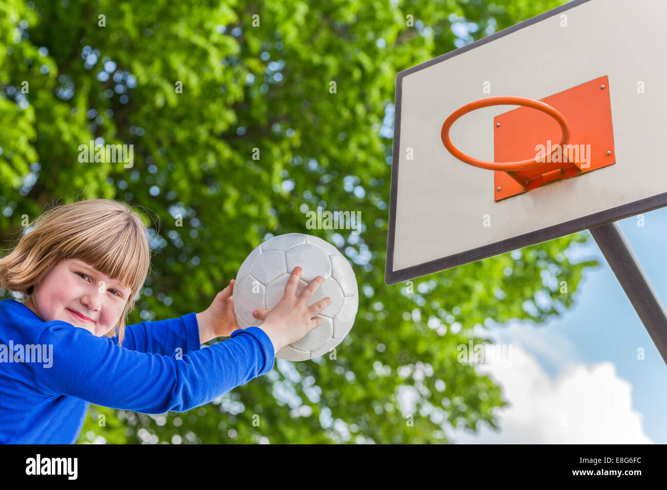 Schoolchild aiming ball at board with basket Stock Photo - Alamy