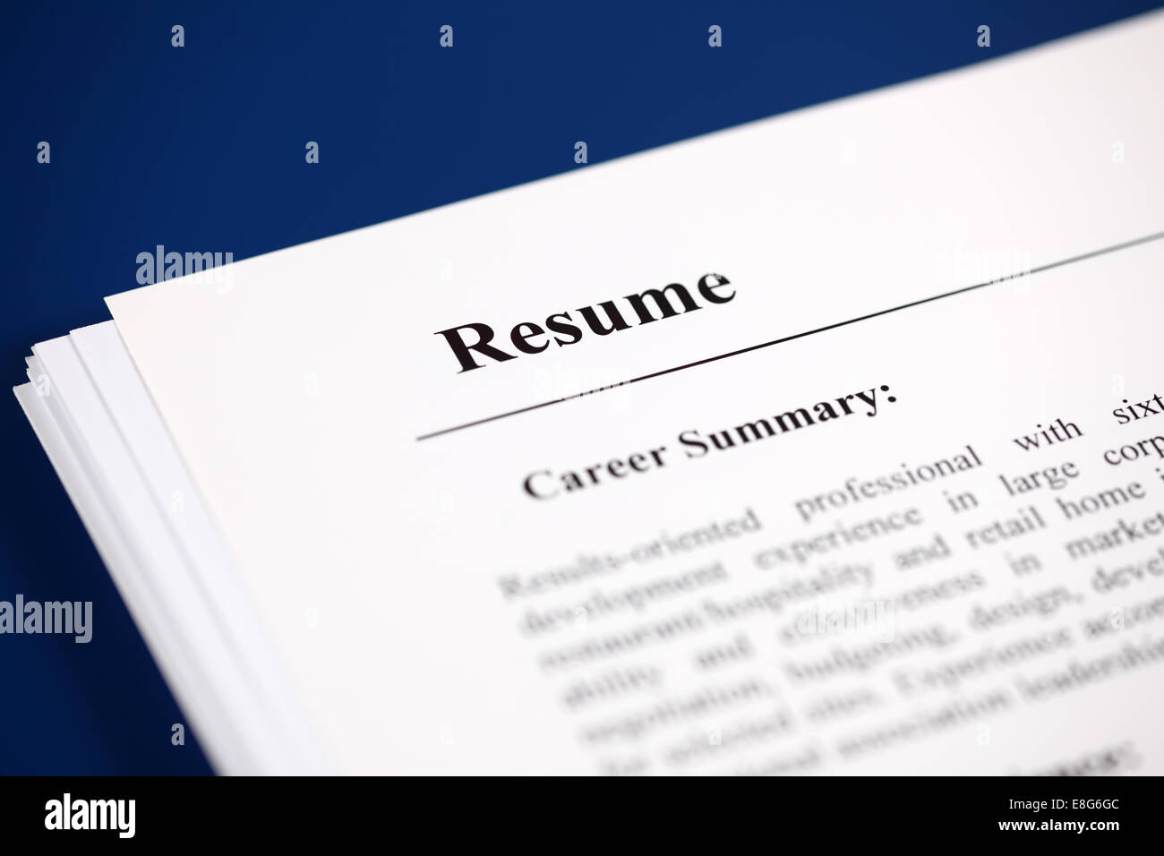 Stack of resumes on a blue background Stock Photo - Alamy