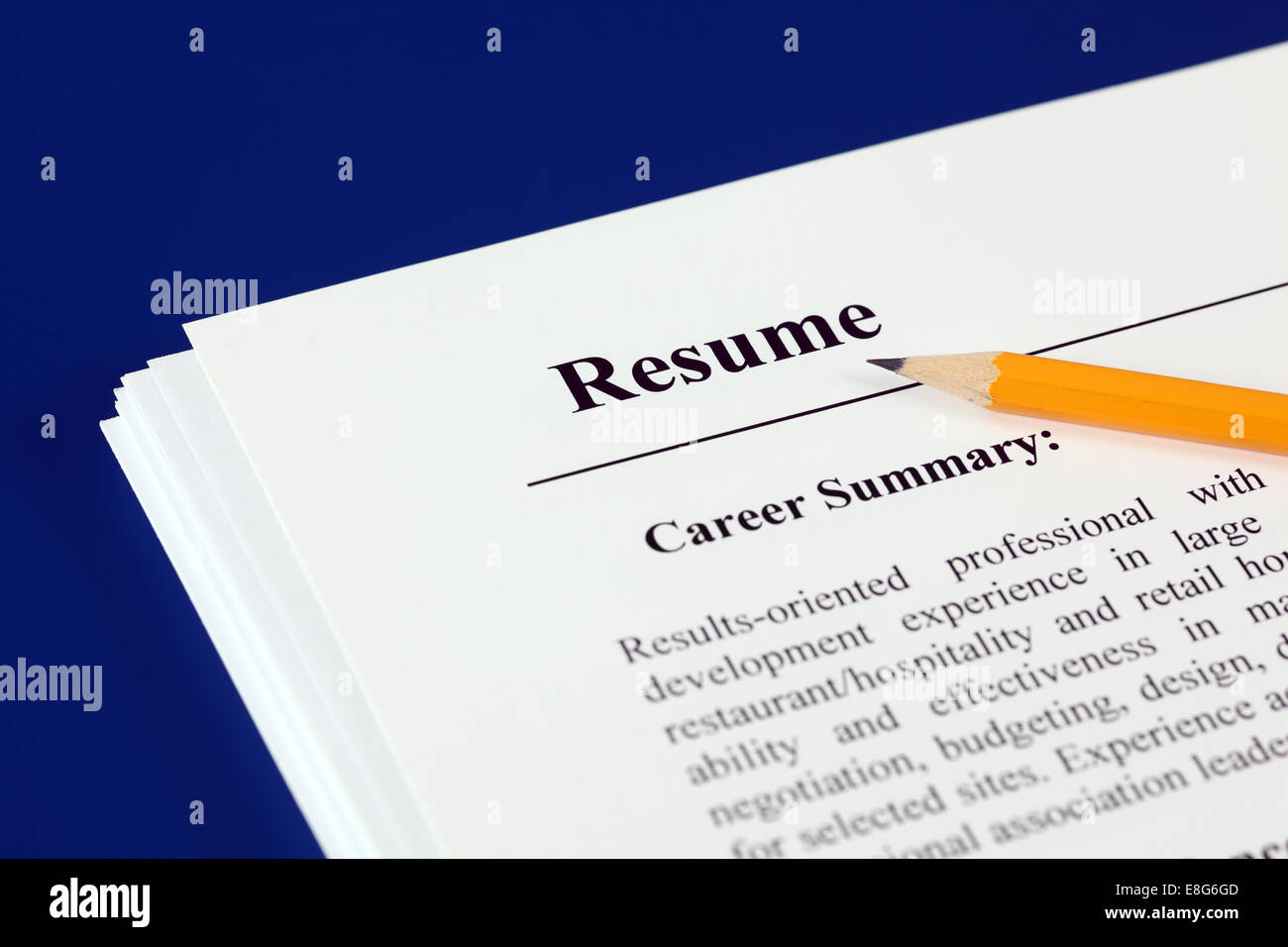 Stack of resumes with pencil on a blue background Stock Photo - Alamy