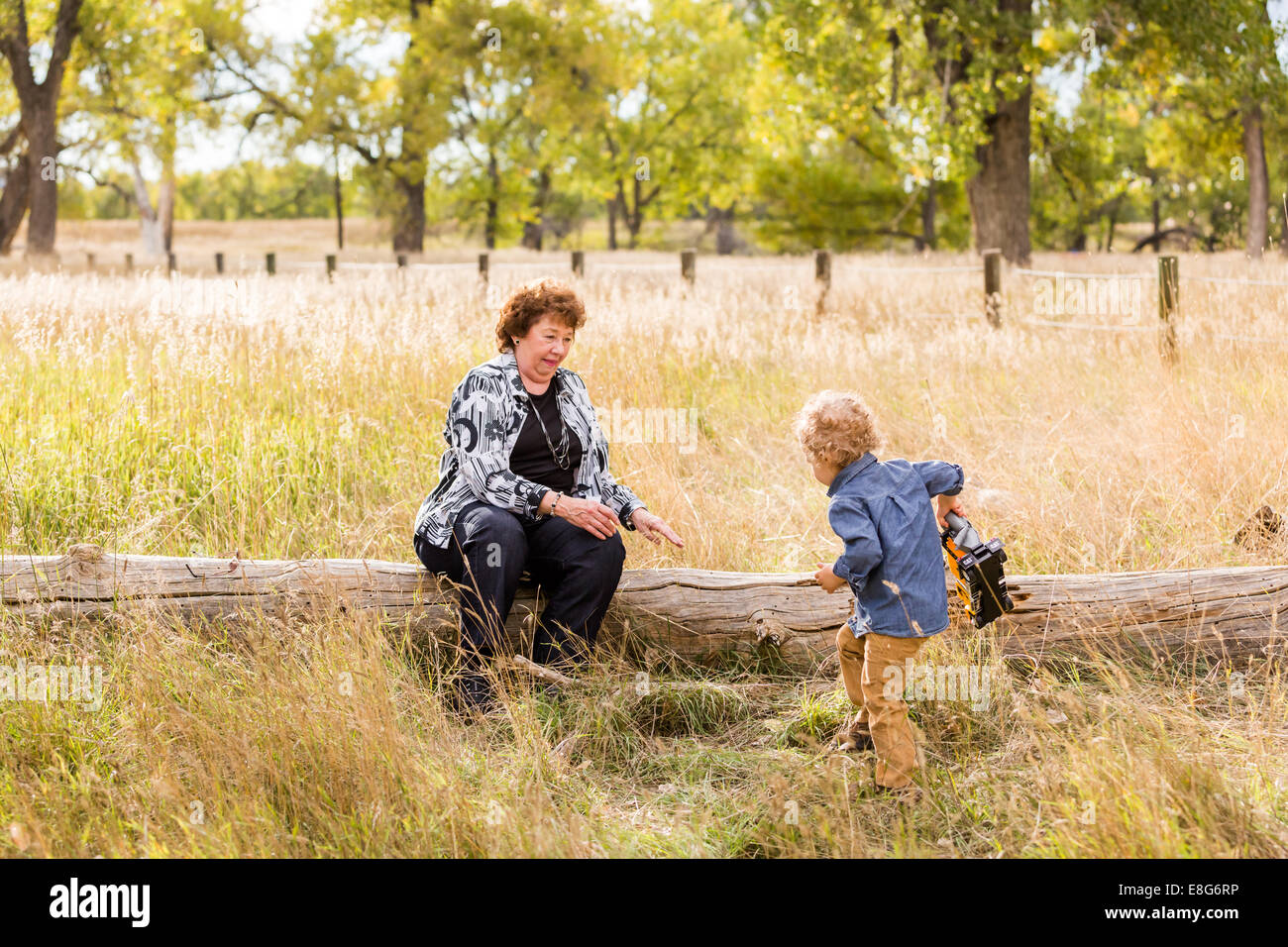 Lovely family enjoying weekend in open space park in early Autumn Stock ...