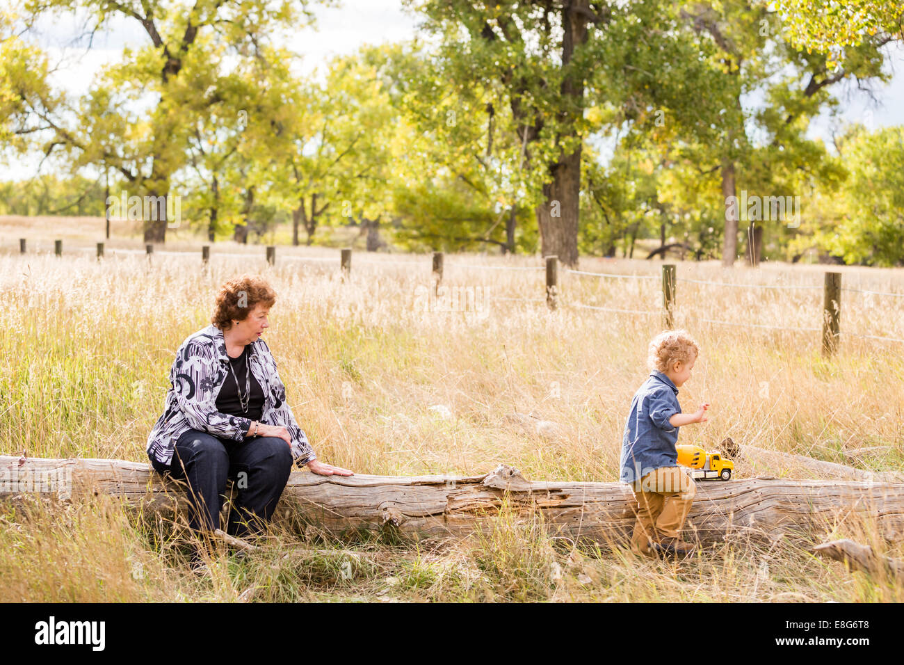 Lovely family enjoying weekend in open space park in early Autumn Stock ...