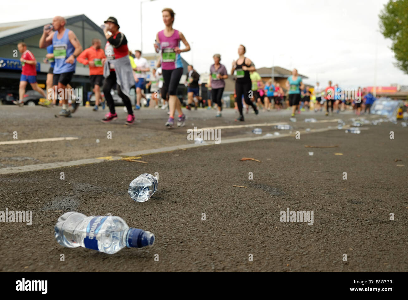 Marathon runners running past bottled water at the Great Scottish Run ...