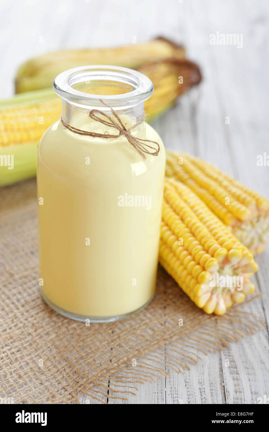 Fresh sweet corn juice (corn milk) in bottle on wooden background Stock ...