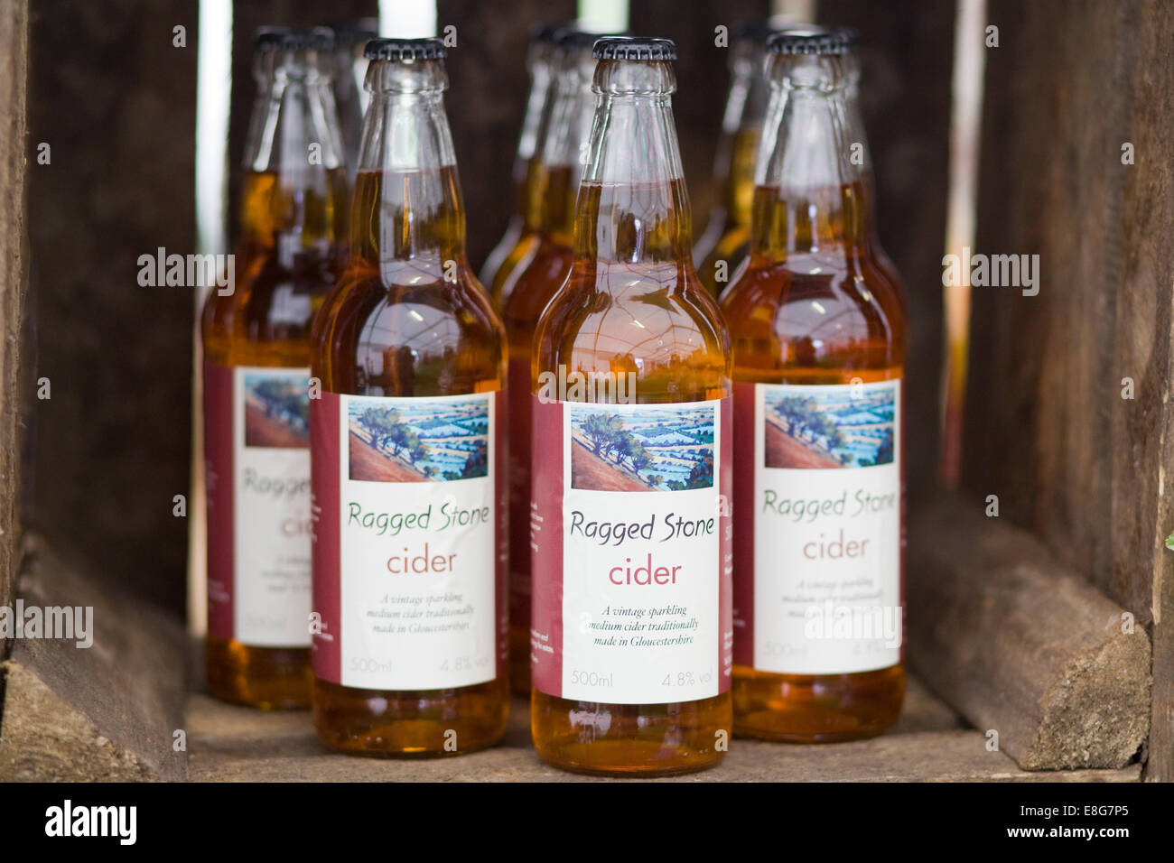 Ragged stone cider Bottles in a wooden create Stock Photo - Alamy