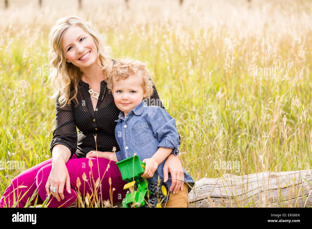 Lovely family enjoying weekend in open space park in early Autumn Stock ...