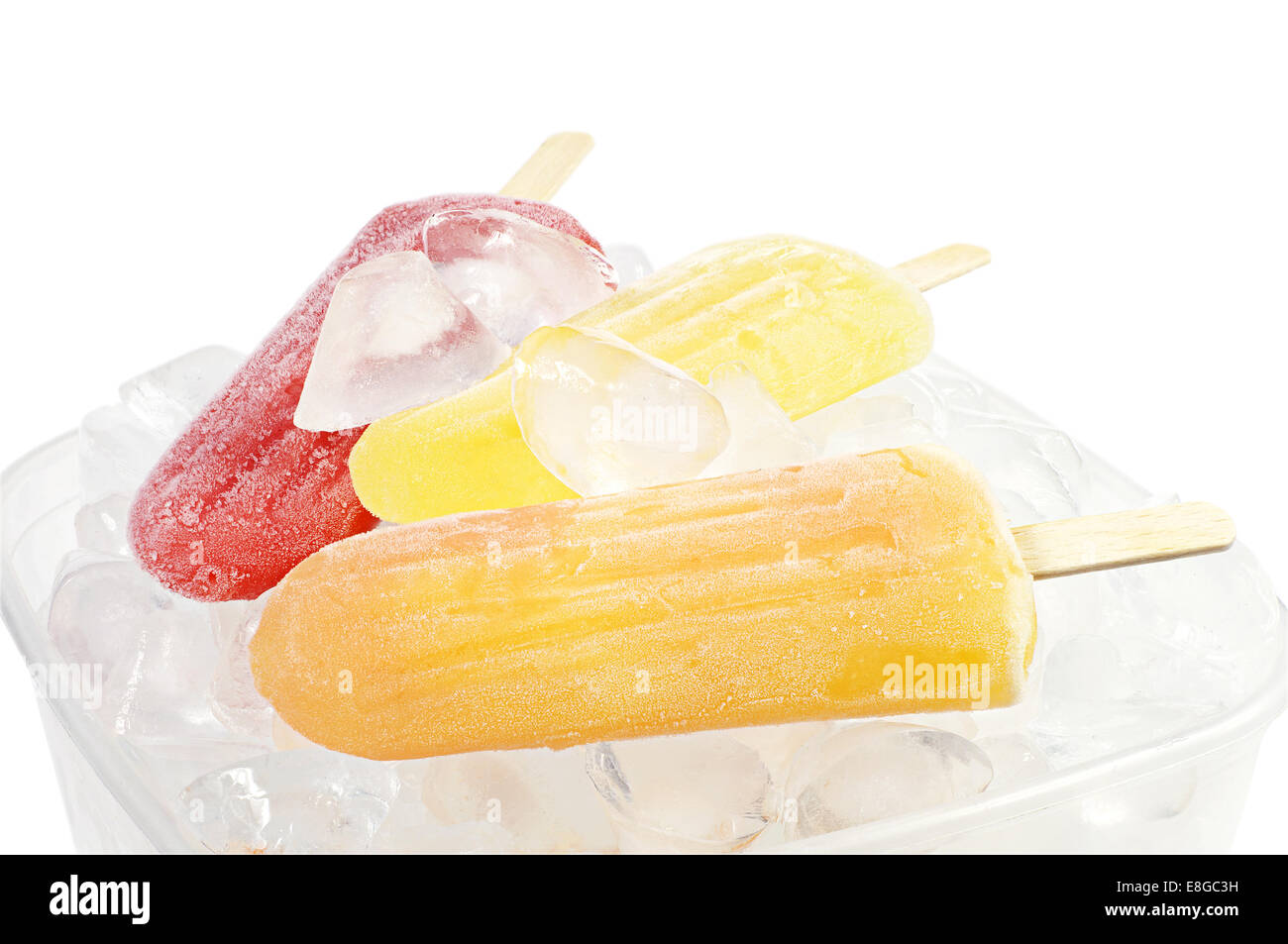 Three colorful fruit popsicle in a bowl of ice isolated on white ...