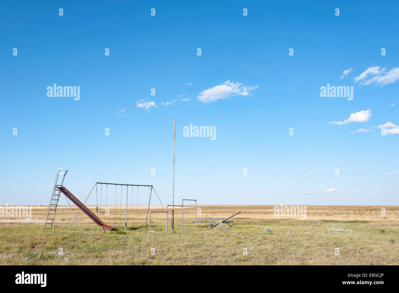 A rusting playground stands in the prairie next to what was once the ...
