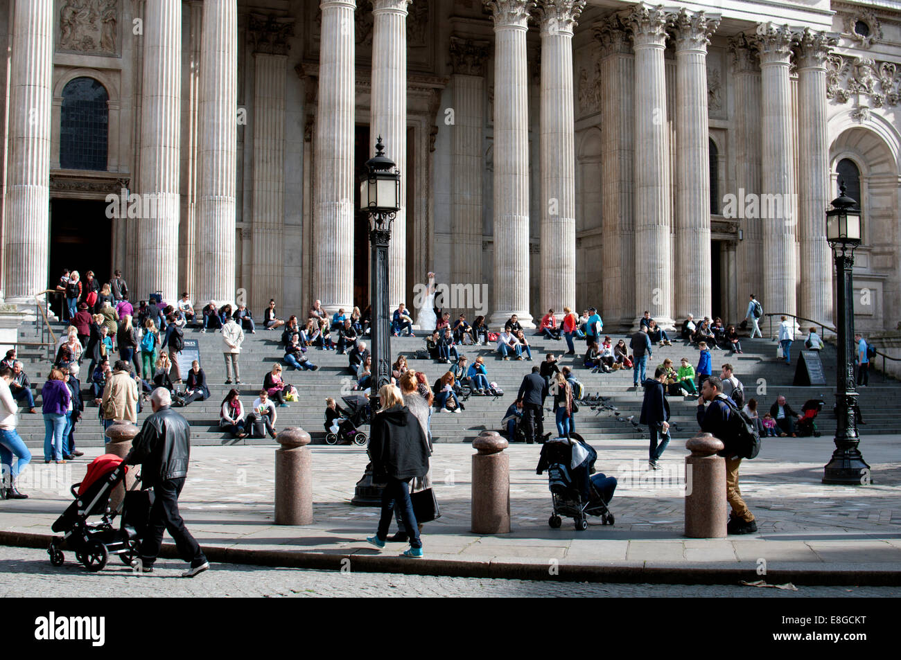 People sitting on the west front steps of St. Paul`s Cathedral, London ...
